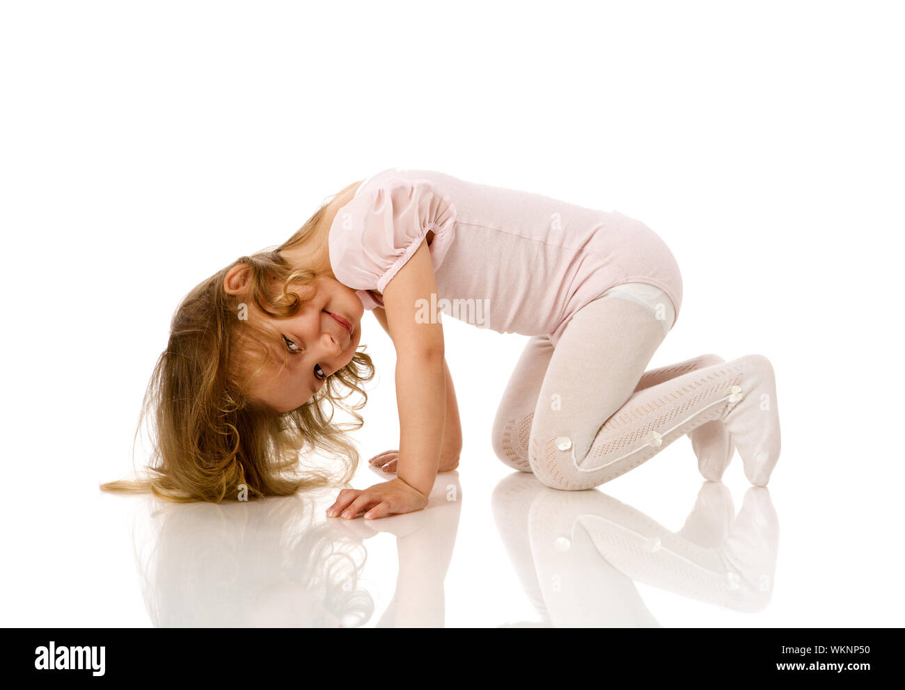 Little girl upside down having fun isolated on white Stock Photo - Alamy