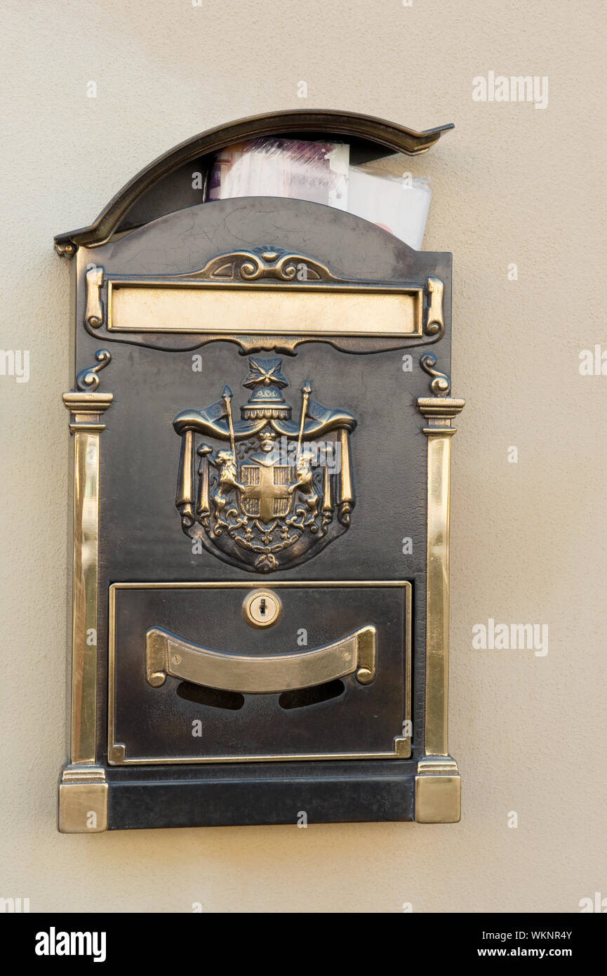 Italian mailbox from copper filled with newspapers Stock Photo - Alamy