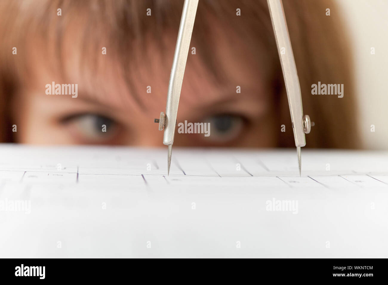 Compasses and the drawing close up on a face background Stock Photo - Alamy
