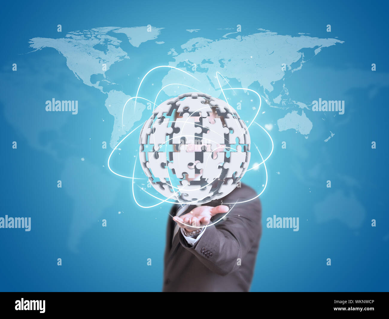 Business man hold exploding ball of gray puzzle pieces in hand. World ...