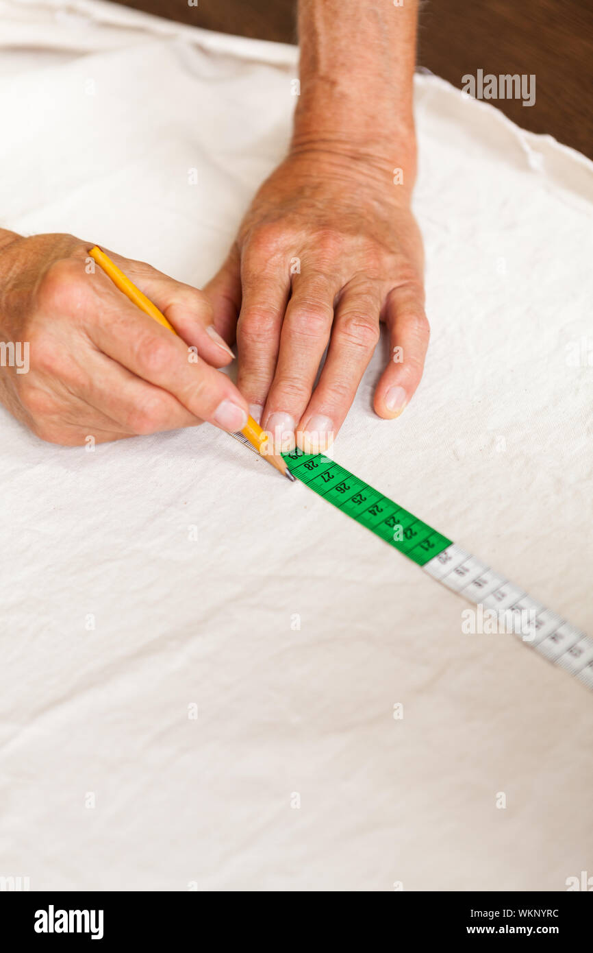 Hand Cutting Cloth with Scissors Stock Photo - Alamy