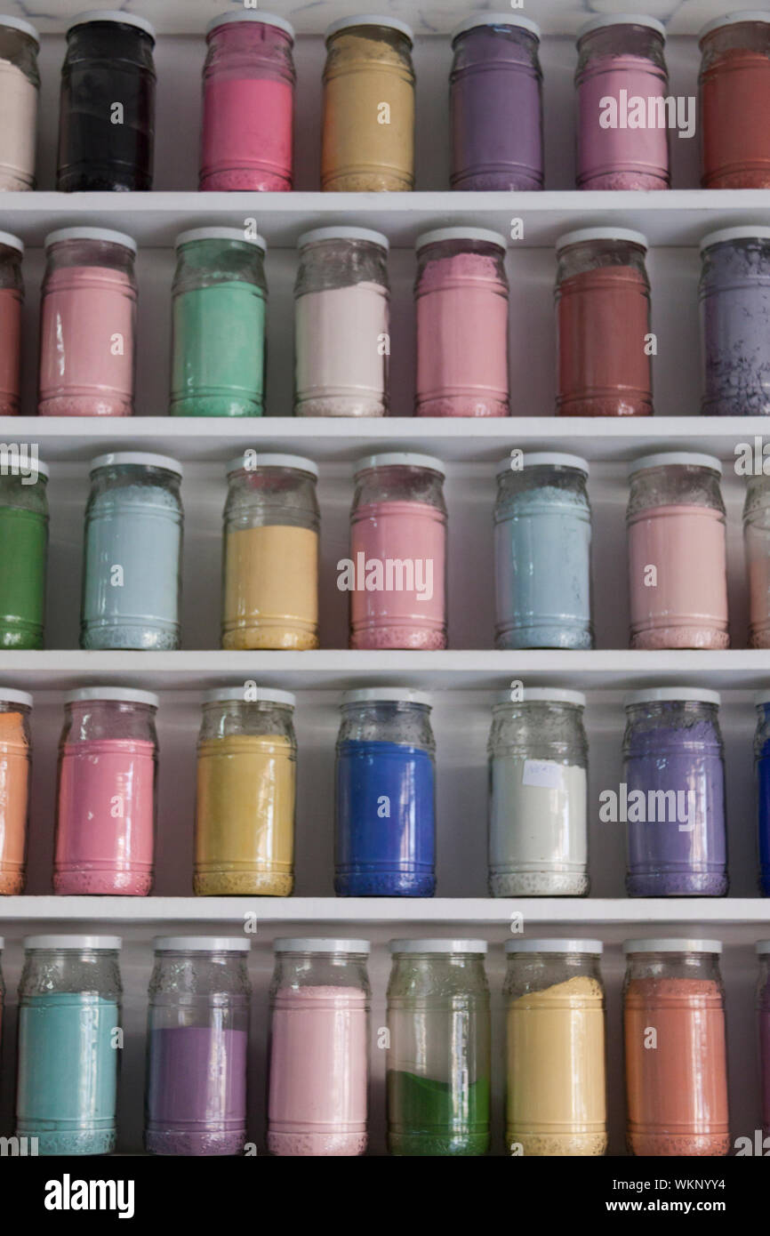 Shelving with glass jars of colorful pigments Stock Photo - Alamy