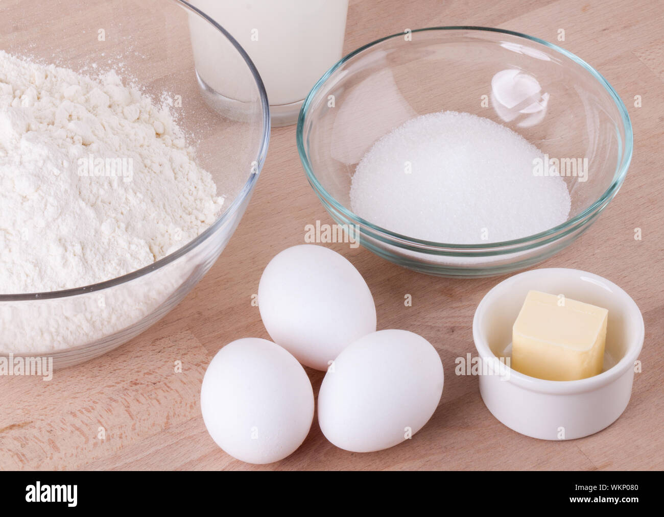 Baking ingredients in the kitchen with a bowl of flour, eggs, sugar ...