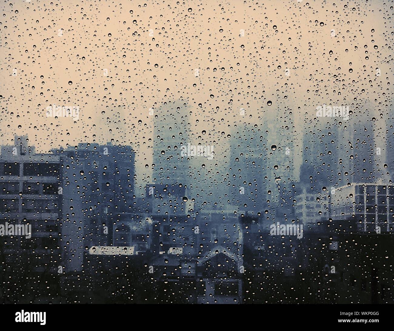 Buildings Seen From Glass Window During Rainy Season Stock Photo - Alamy