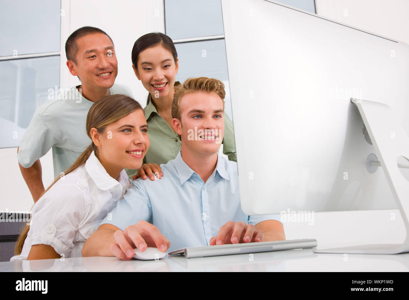Multi ethnic group of people looking computer Stock Photo - Alamy