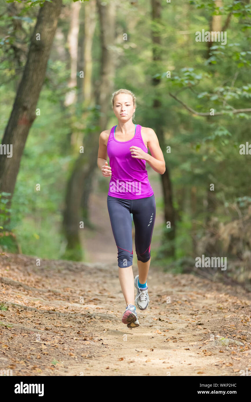 Pretty young girl runner in the forest. Running woman. Female Runner ...