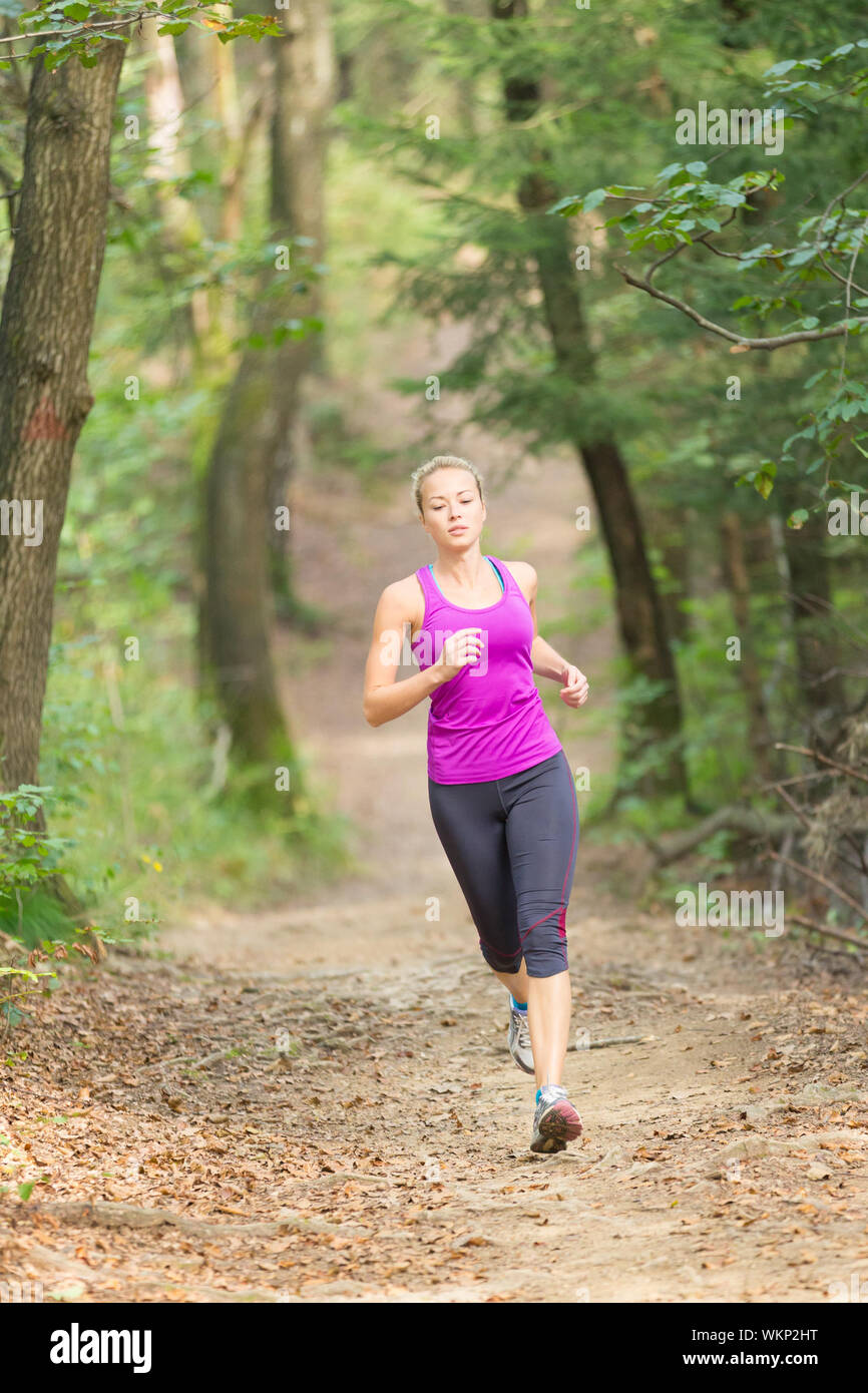Pretty young girl runner in the forest. Running woman. Female Runner ...