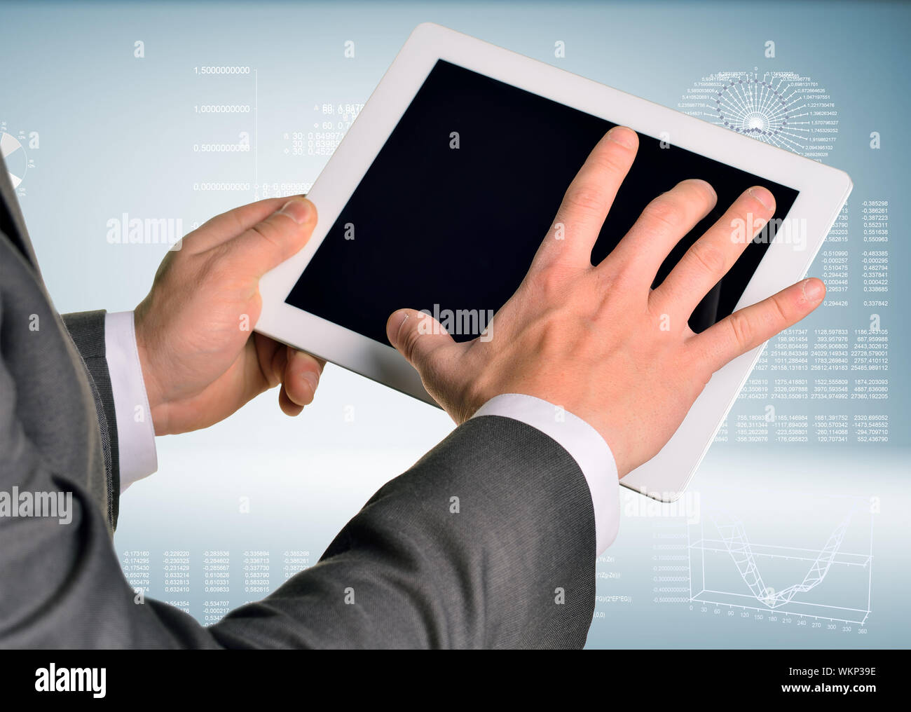Two hands using tablet pc. Hi-tech background with graphs and figures ...