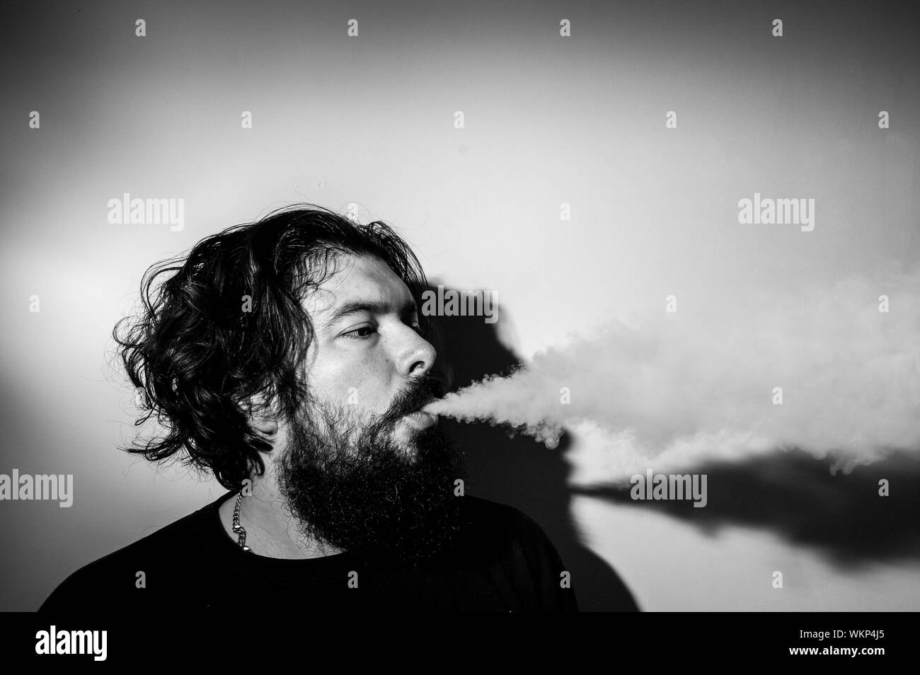Blowing smoke hi-res stock photography and images - Alamy