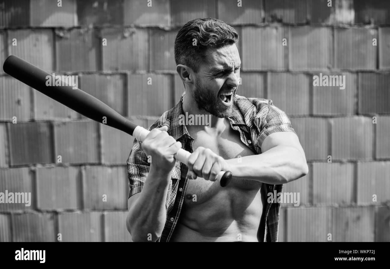 full of energy. unshaven muscular man fighting. man with baseball bat ...