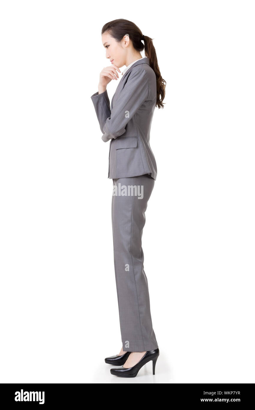 Side view of Asian business woman thinking, full length portrait ...
