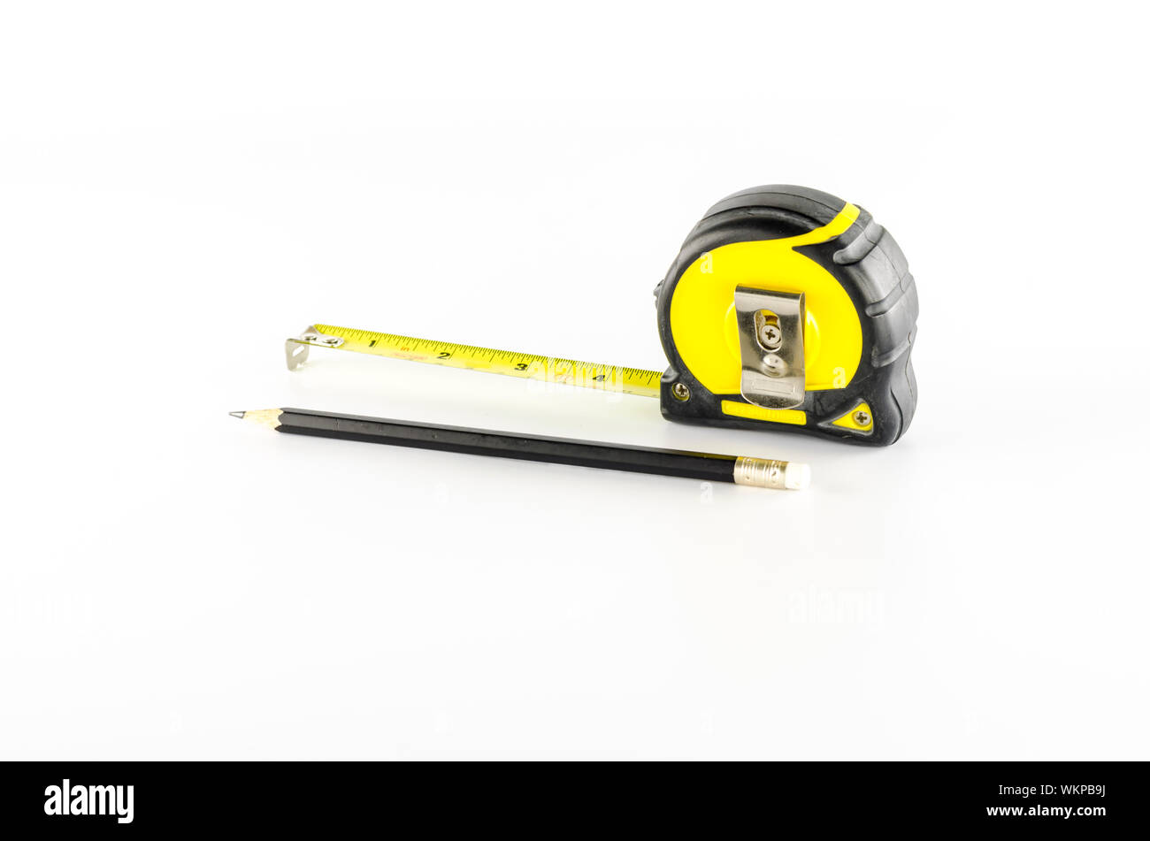 measuring tape with pencil on a white background Stock Photo - Alamy