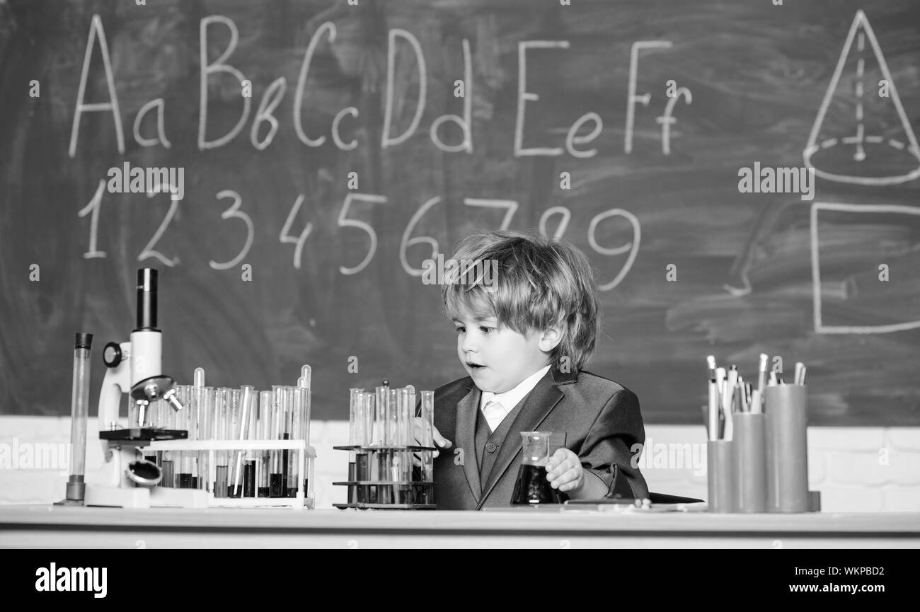 Educational experiment. Happy childhood. Boy near microscope and test ...