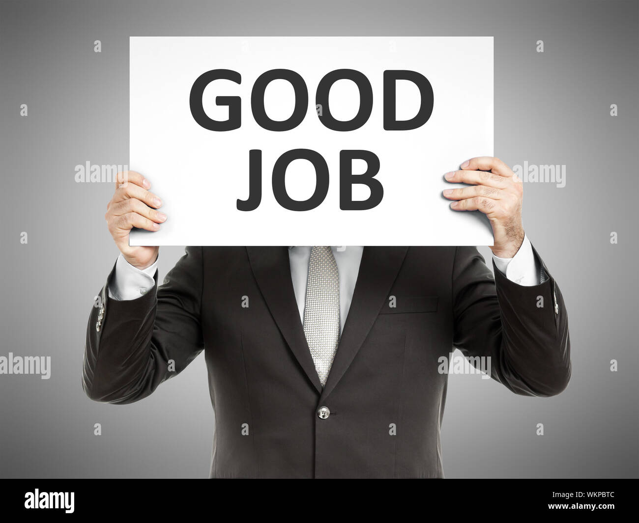 A business man holding a paper in front of his face with the text good ...