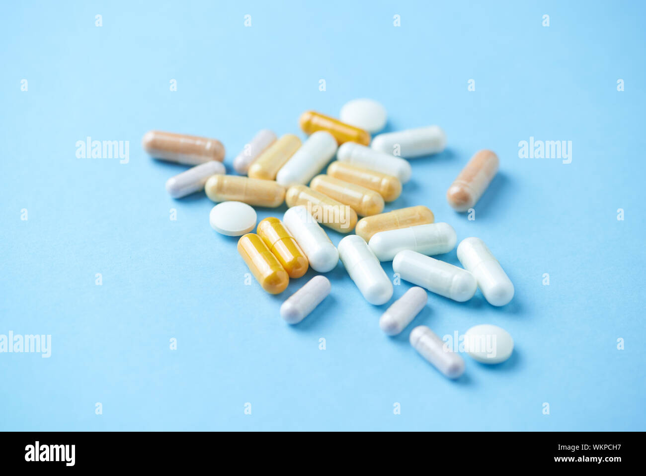 Vitamins and supplements on bright paper background. Concept for a ...