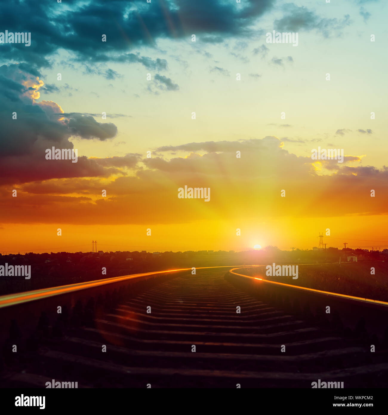 red dramatic sunset over railroad with reflections Stock Photo - Alamy