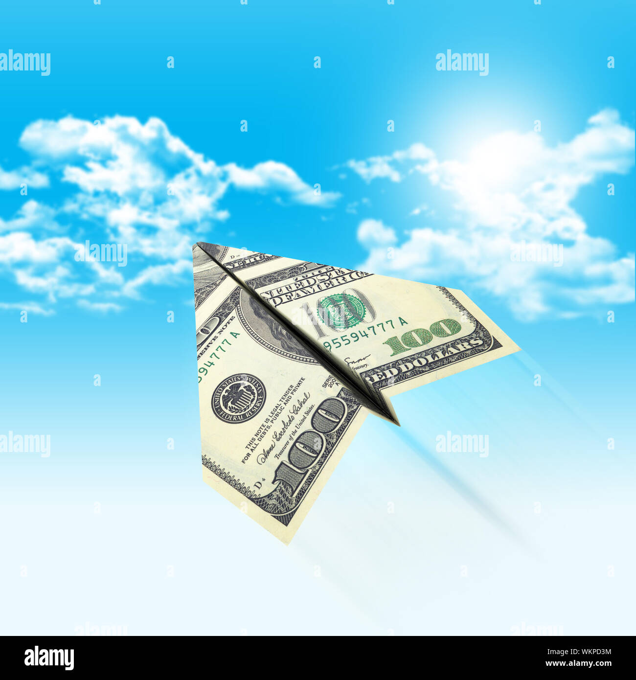 Paper airplane made of hundred dollar bill. Sky and clouds in the ...