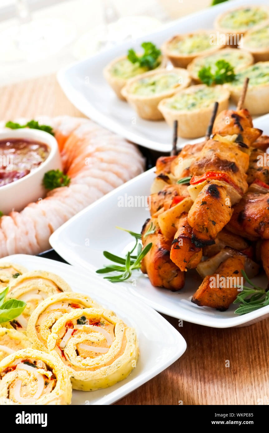 Many dishes of bite size appetizers and party food Stock Photo - Alamy
