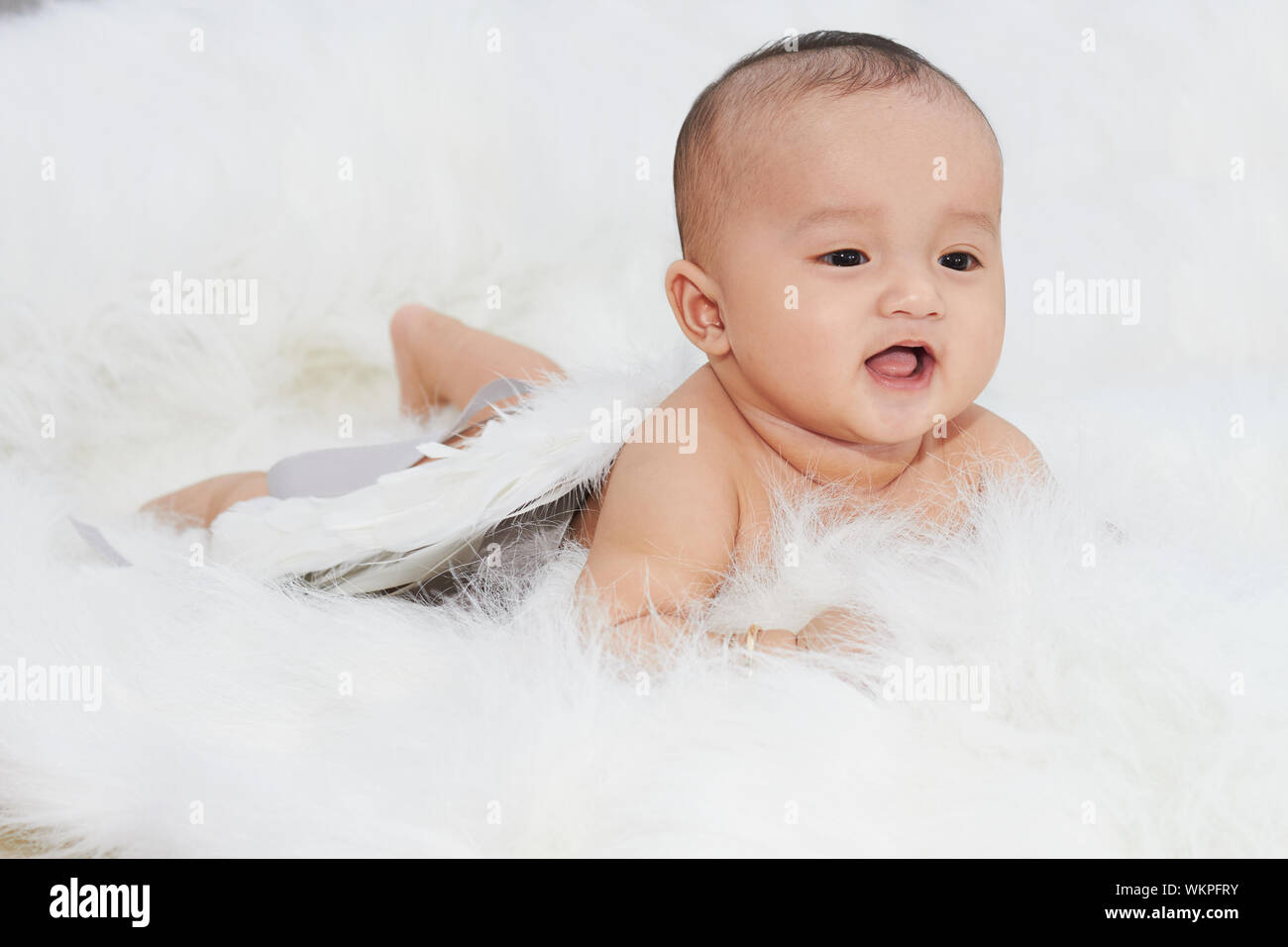 Baby lying on fur rug hi-res stock photography and images - Alamy