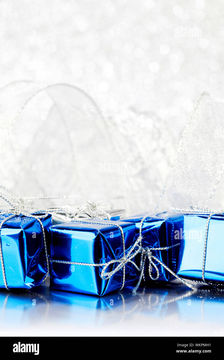 Decorative blue boxes with holiday gifts on shiny glitter background ...