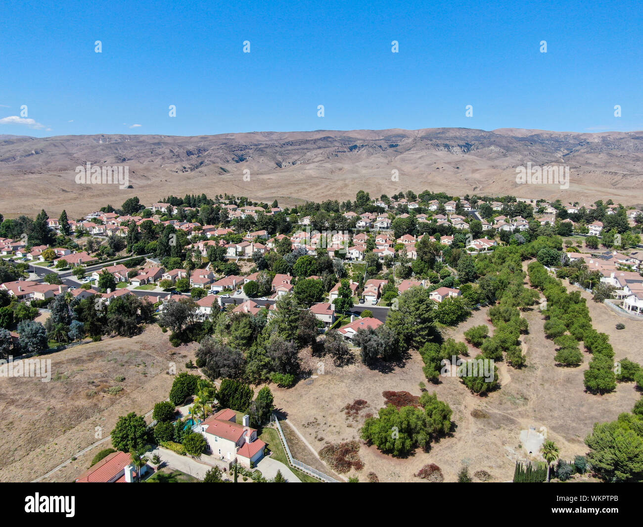 Aerial view of small neighborhood with dry desert mountain on the ...
