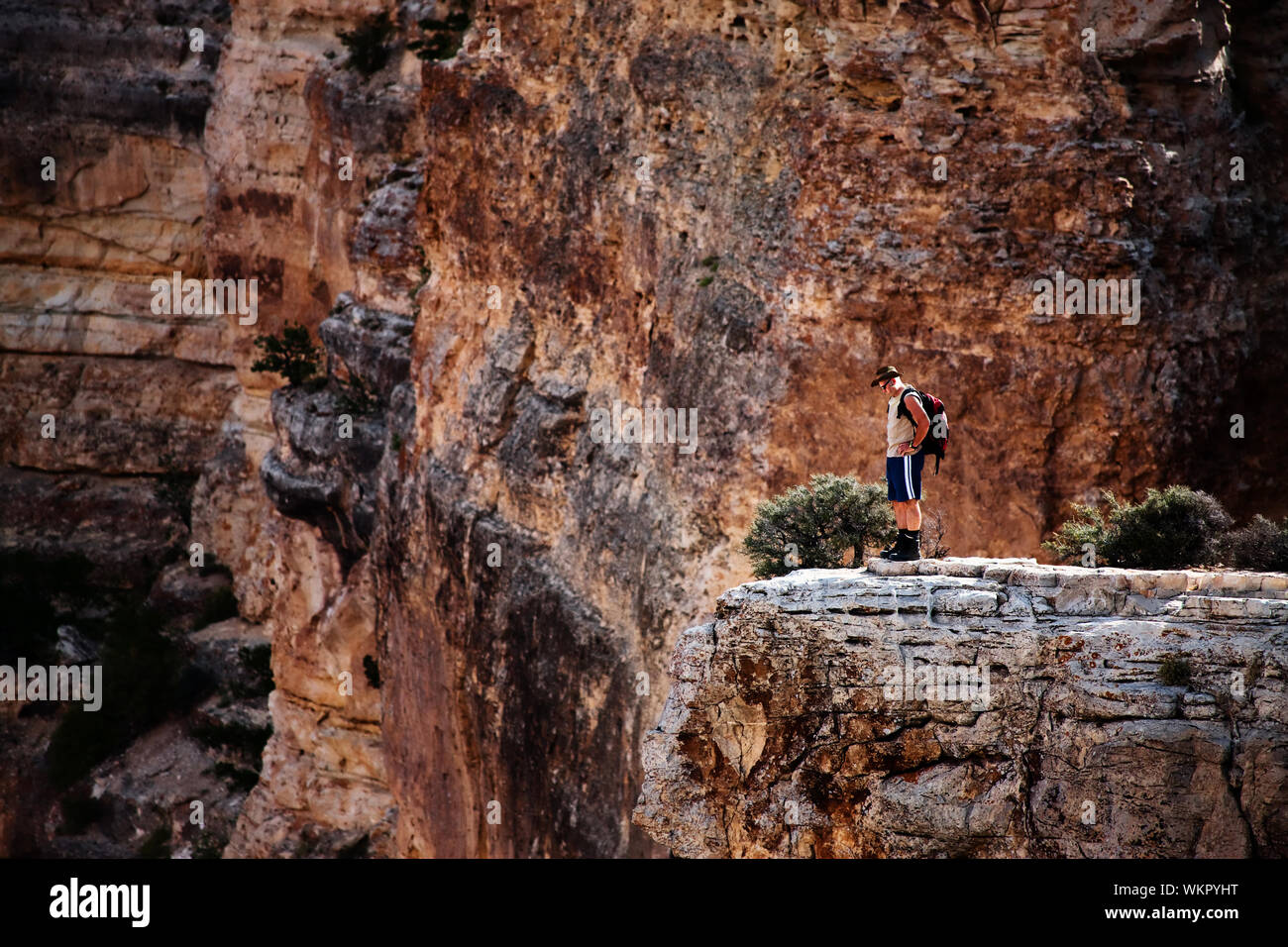 Man standing on cliff ledge hi-res stock photography and images - Alamy