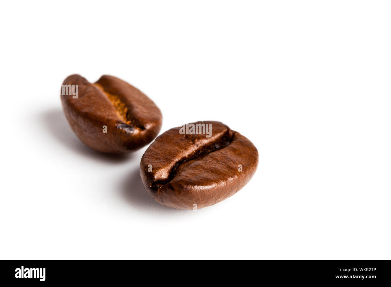 macro shot of two coffee beans isolated on white background Stock Photo ...