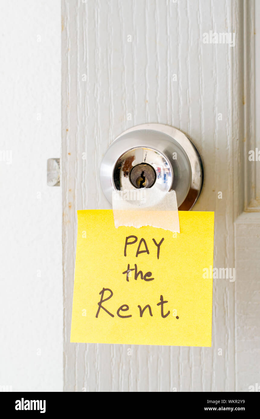 sticky note write a message pay the rent on the latch door Stock Photo ...