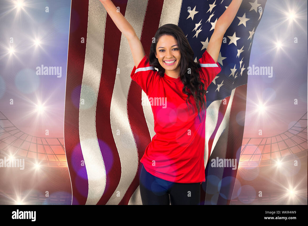Cheering football fan in red holding usa flag against large football ...