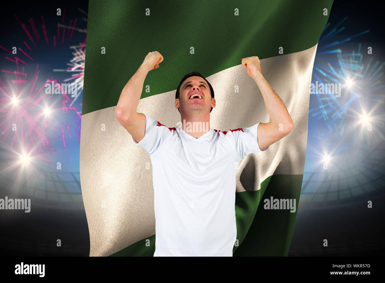 Cheering football fan in white against fireworks exploding over ...