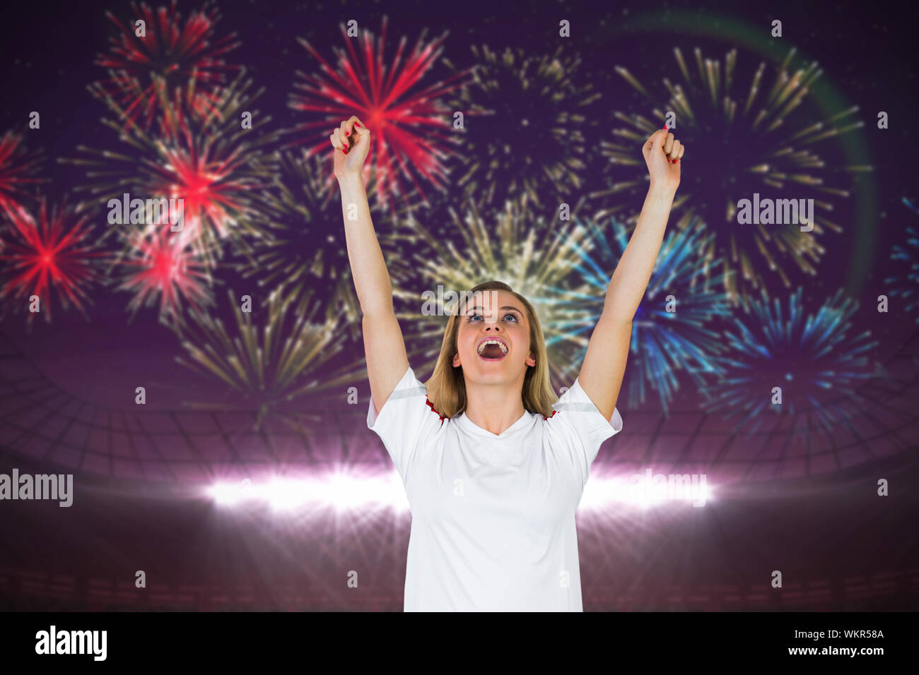 Cheering football fan in white against fireworks exploding over ...