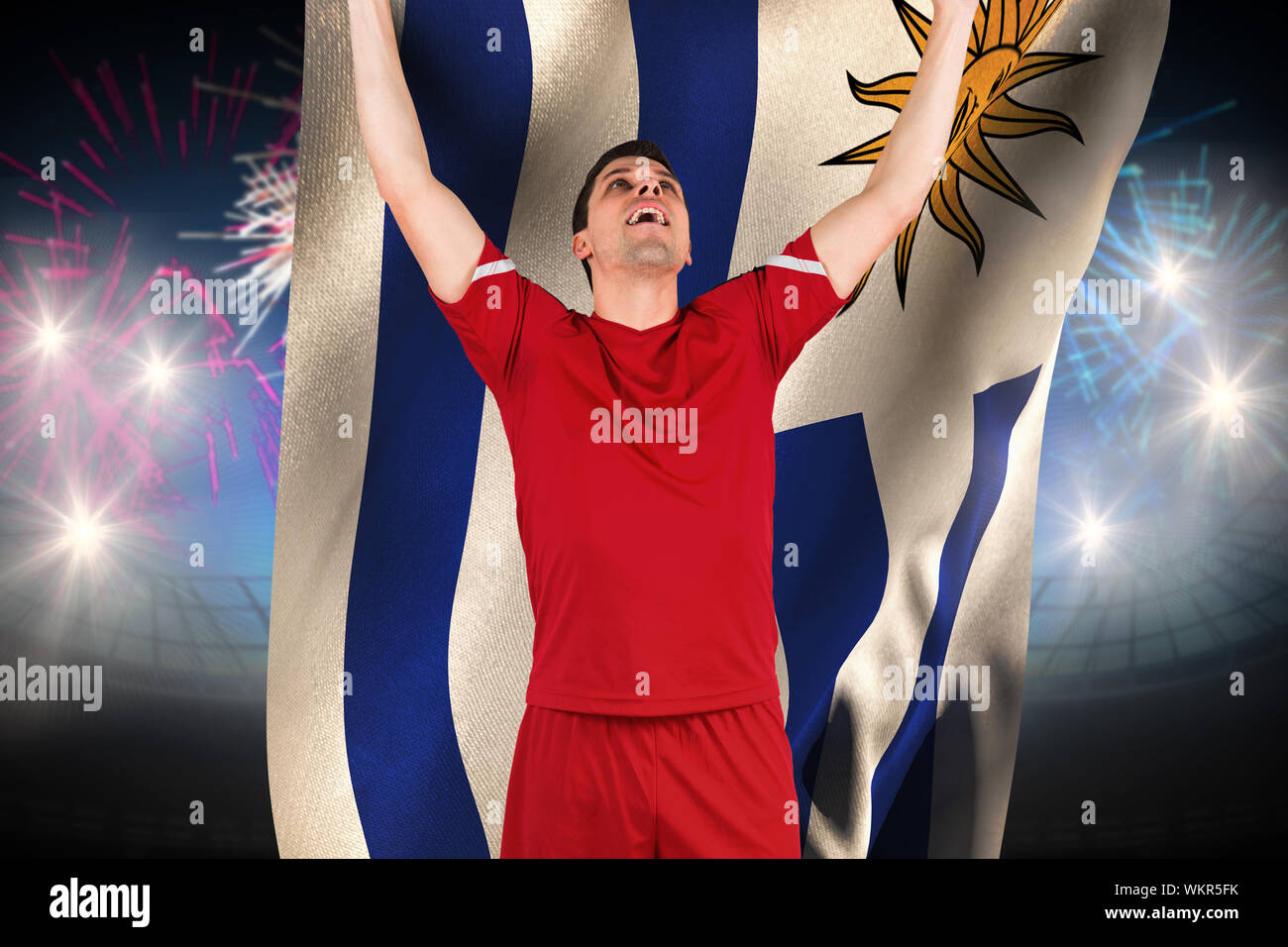 Excited football player cheering against fireworks exploding over ...