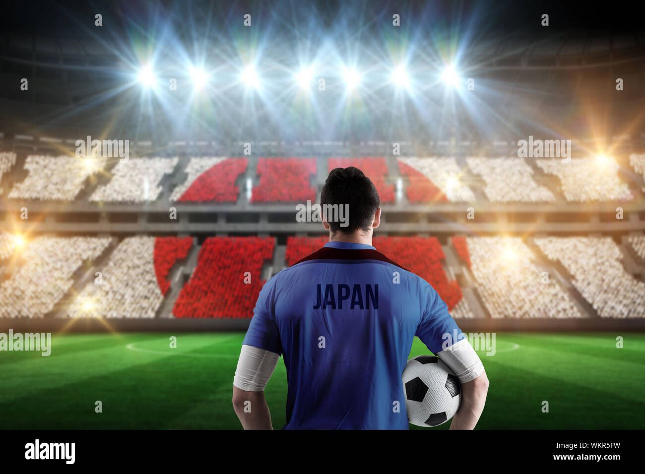 Japan football player holding ball against stadium full of japan ...