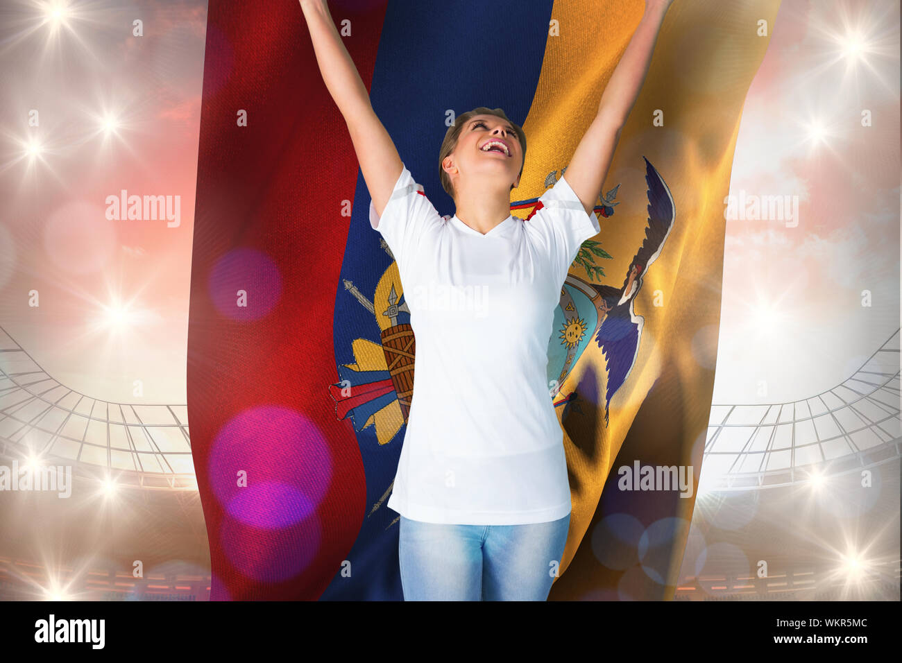 Pretty football fan in white cheering holding ecuador flag against ...