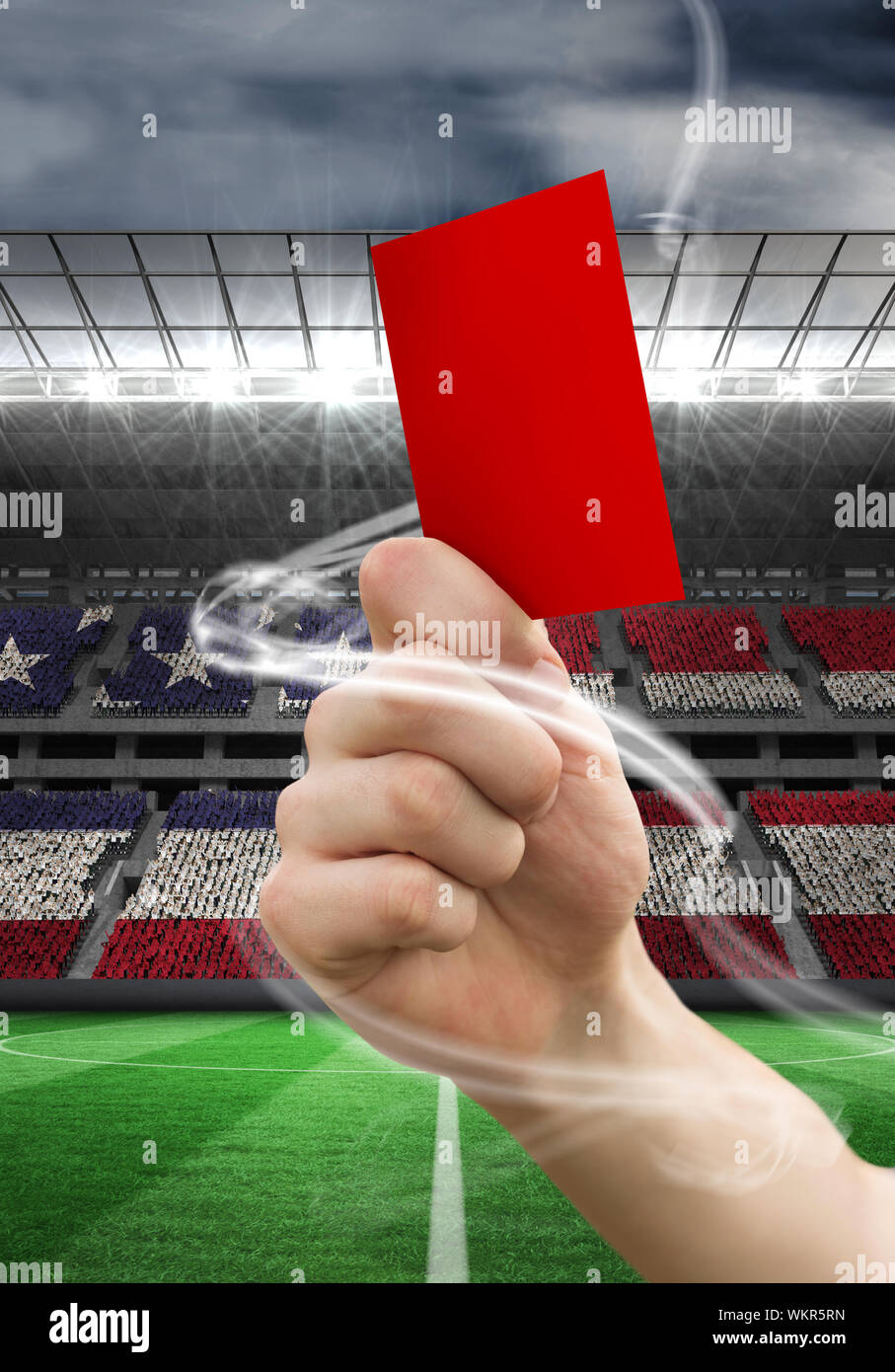 Hand holding up red card against stadium full of usa football fans ...