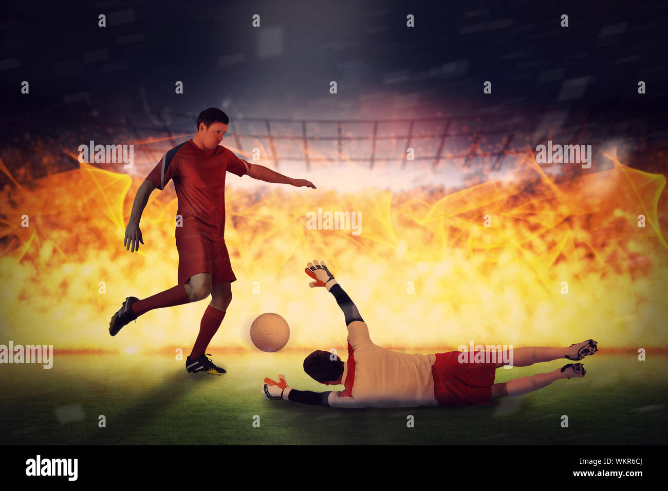 Football players tackling for the ball against large football stadium ...