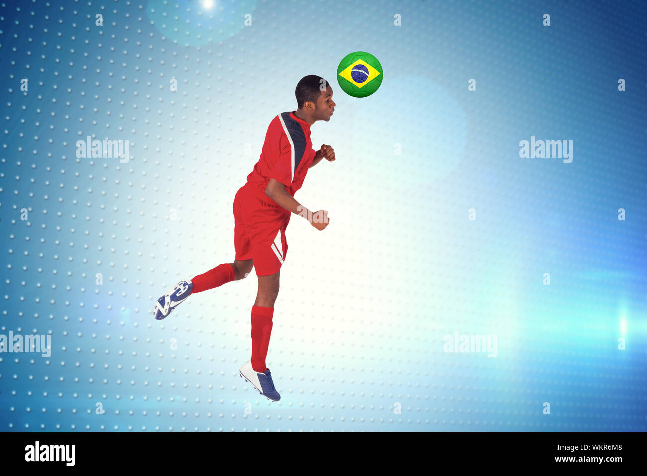 Football player in red jumping against technical screen with pixels ...