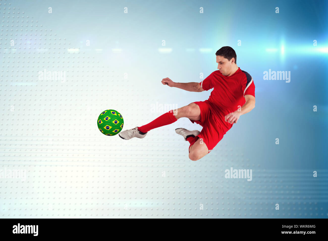 Fit football player jumping and kicking against technical screen with ...