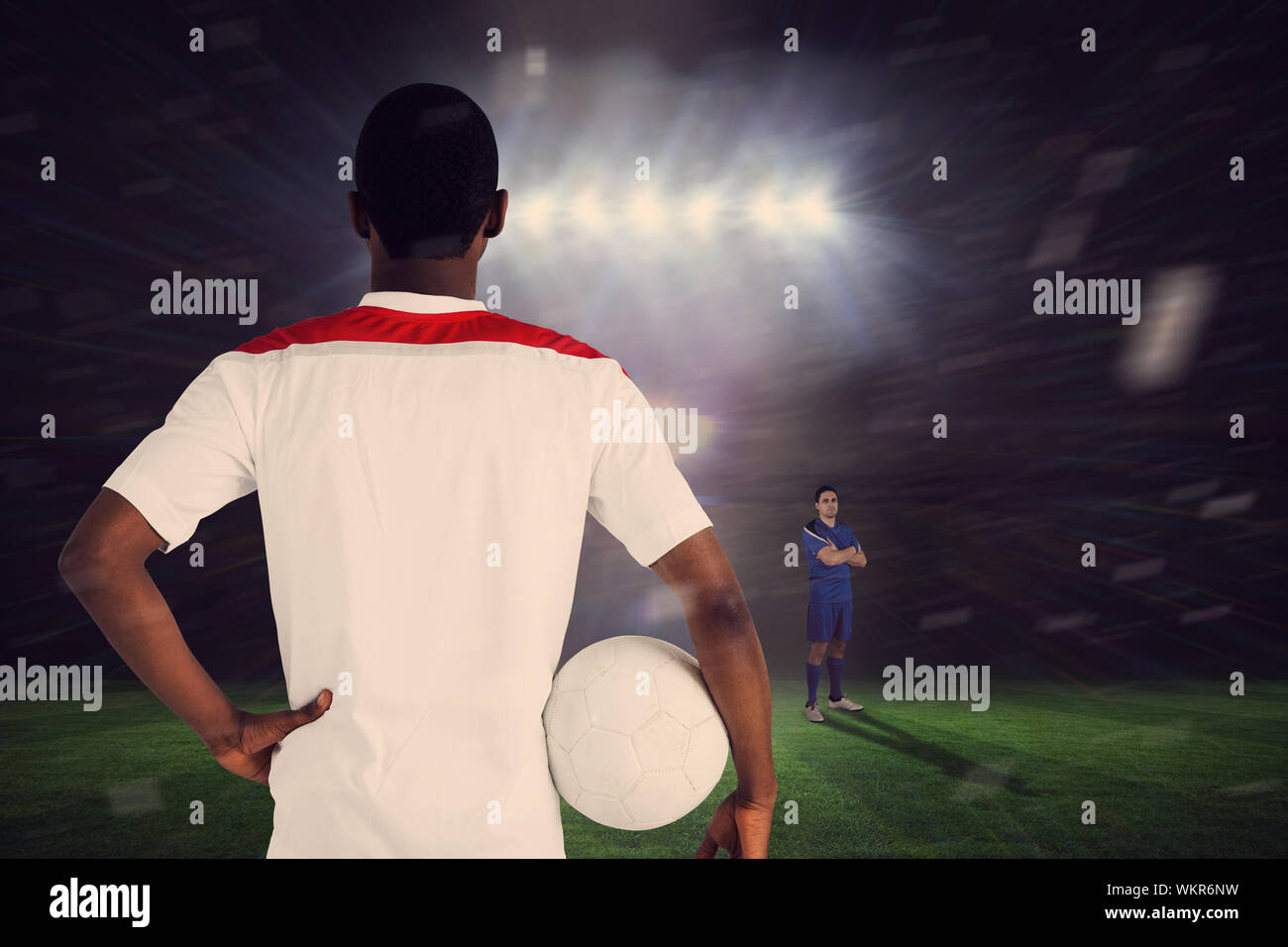 Football players facing off in large digitally generated stadium Stock ...