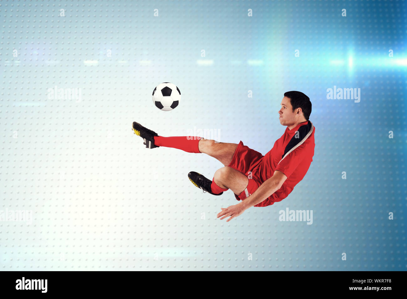 Football player in red kicking against technical screen with pixels ...