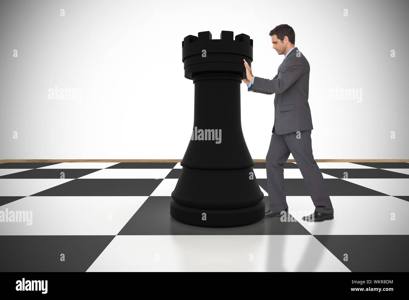 Businessman pushing chess piece against white background with vignette ...
