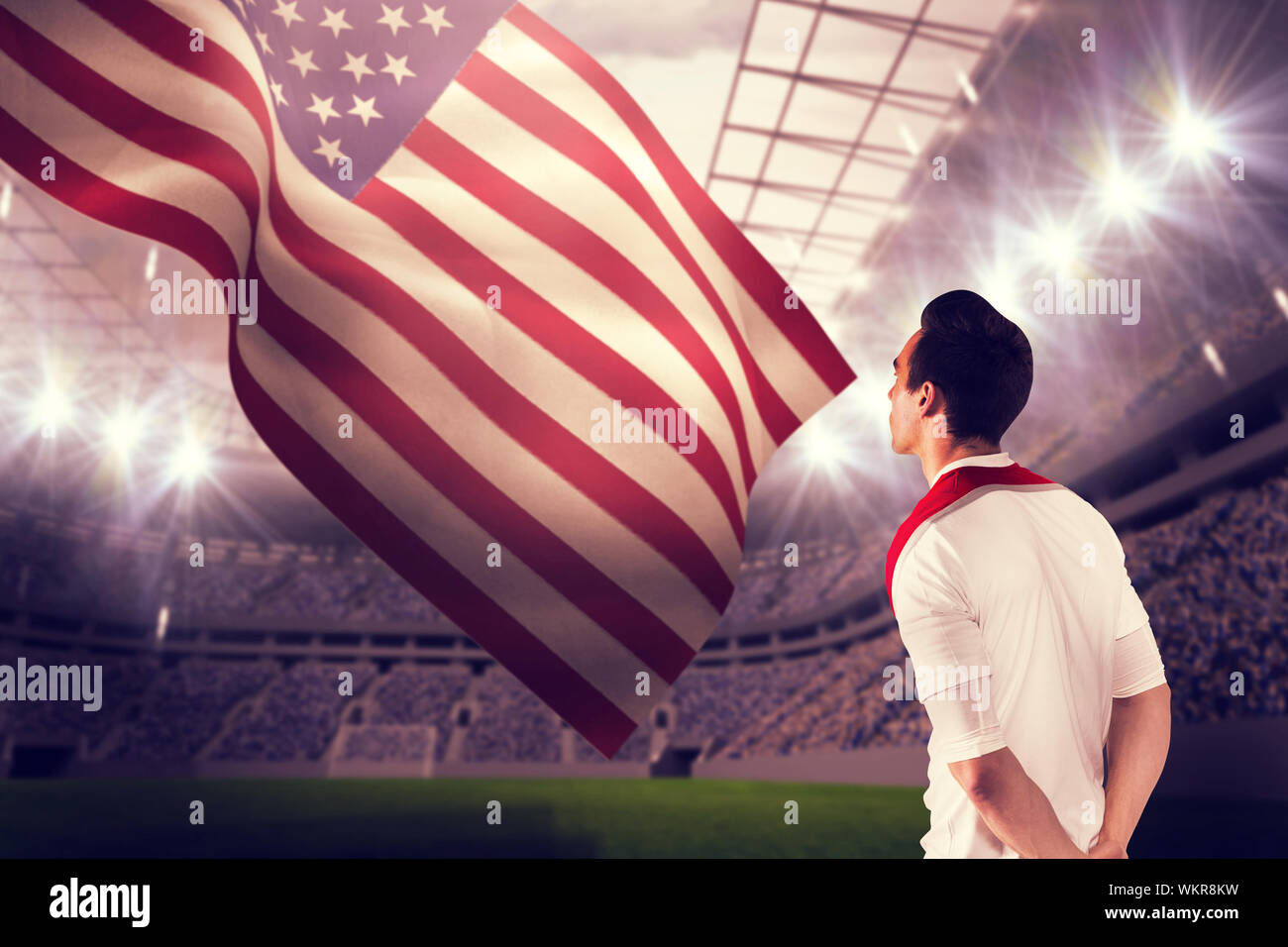 Handsome football fan looking ahead against football stadium Stock ...