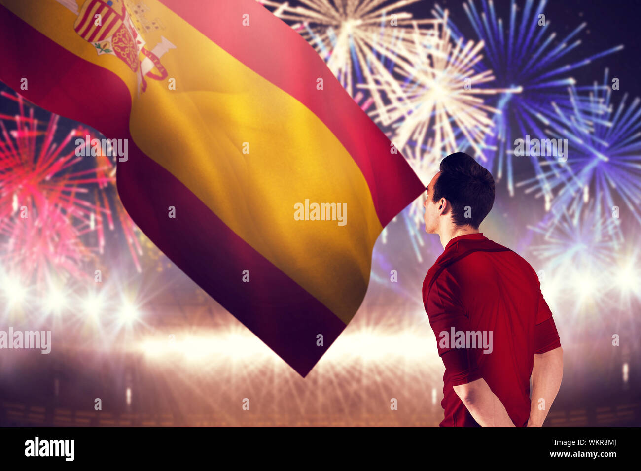 Football player in red jersey against fireworks exploding over football ...