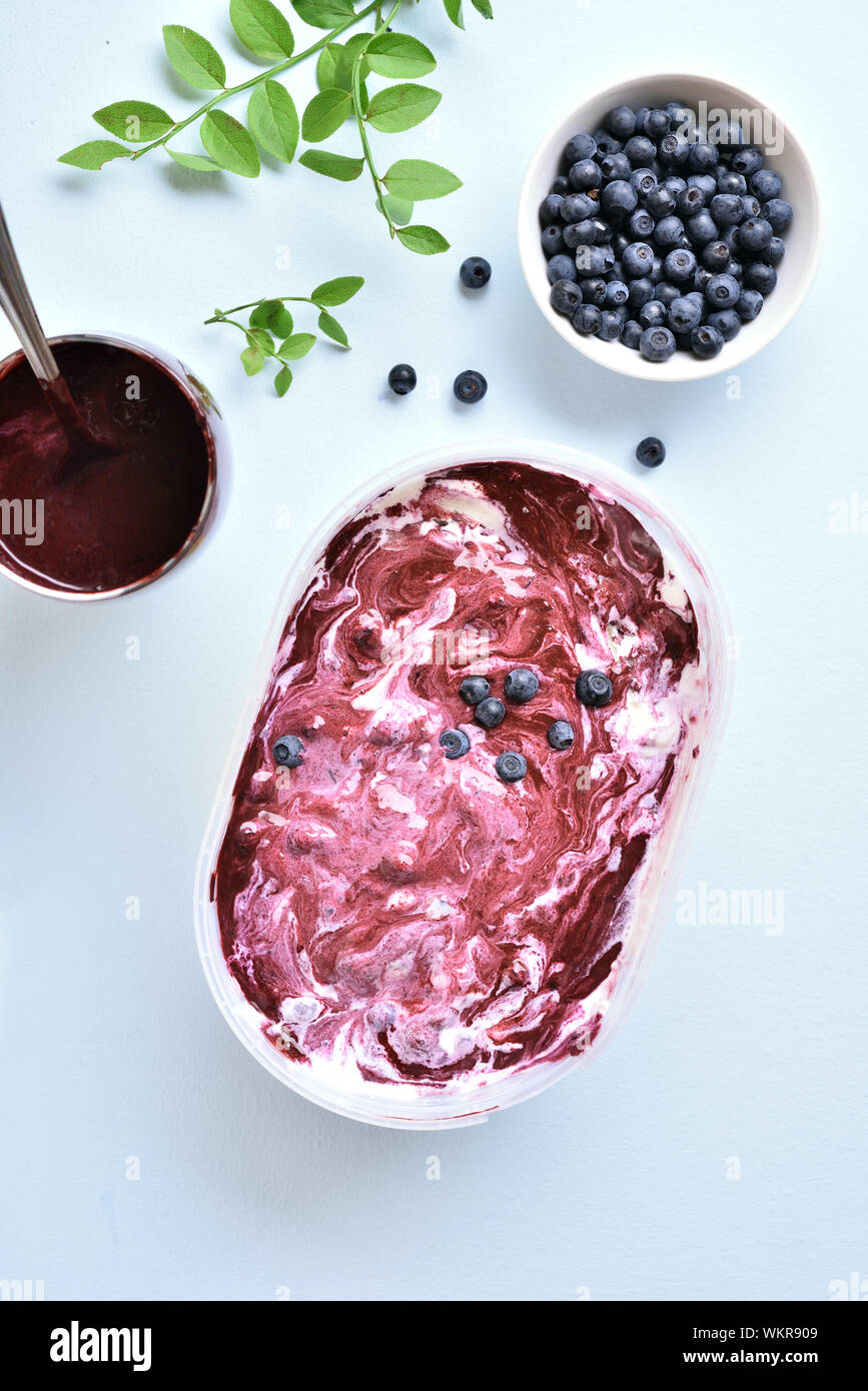 Blueberry ice cream in bowl on blue stone background. Top view, flat ...