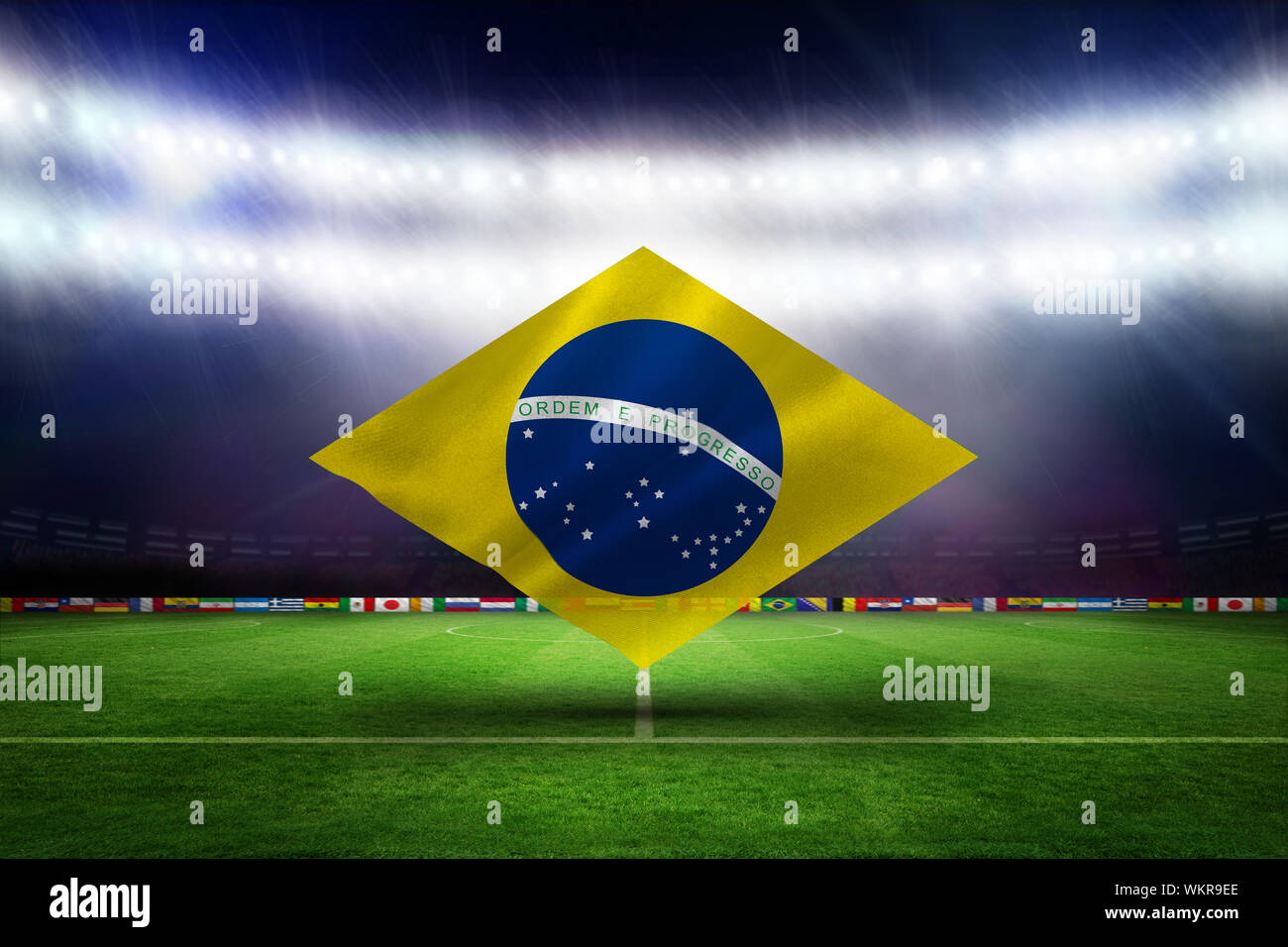 Digitally generated brazilian national flag against football pitch with ...
