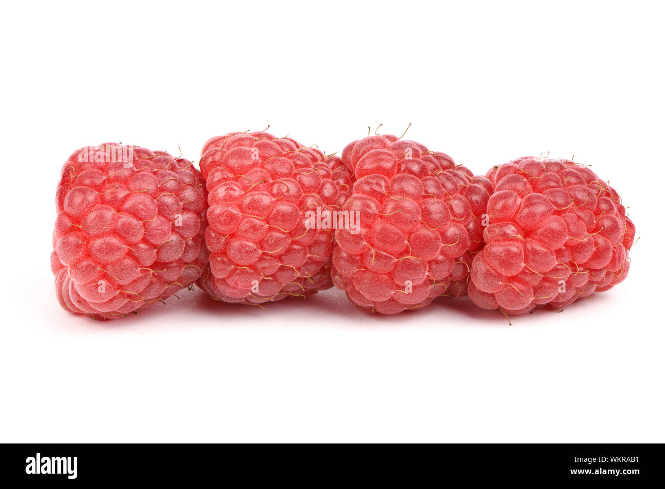 Four red raspberry berries isolated on white background. High ...
