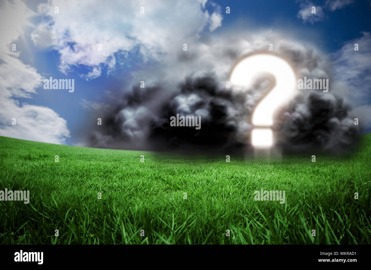 Composite image of question mark in cloud against green field under ...