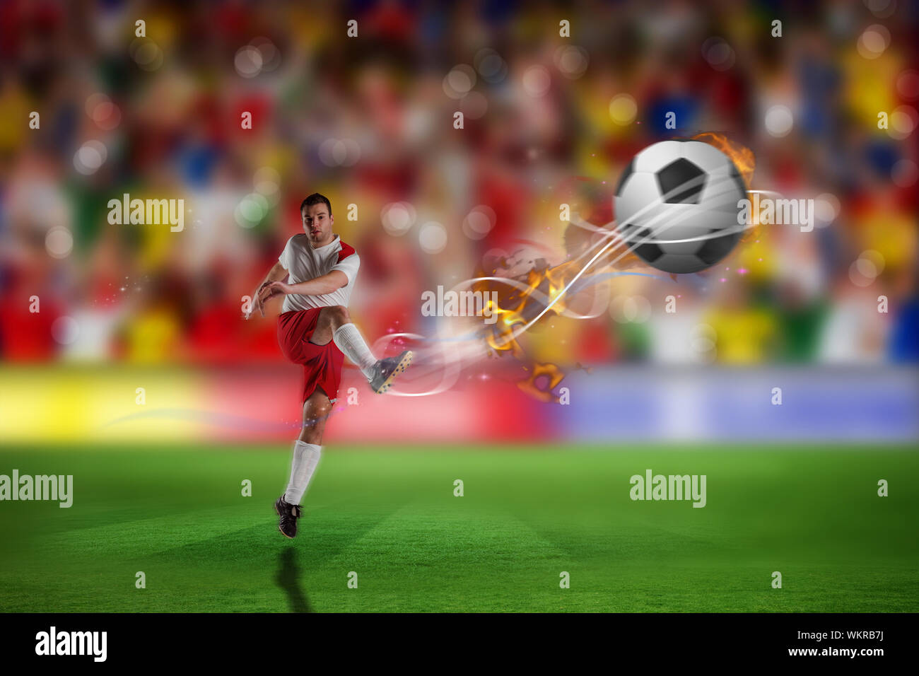 Football player in white kicking against blurry football pitch with ...