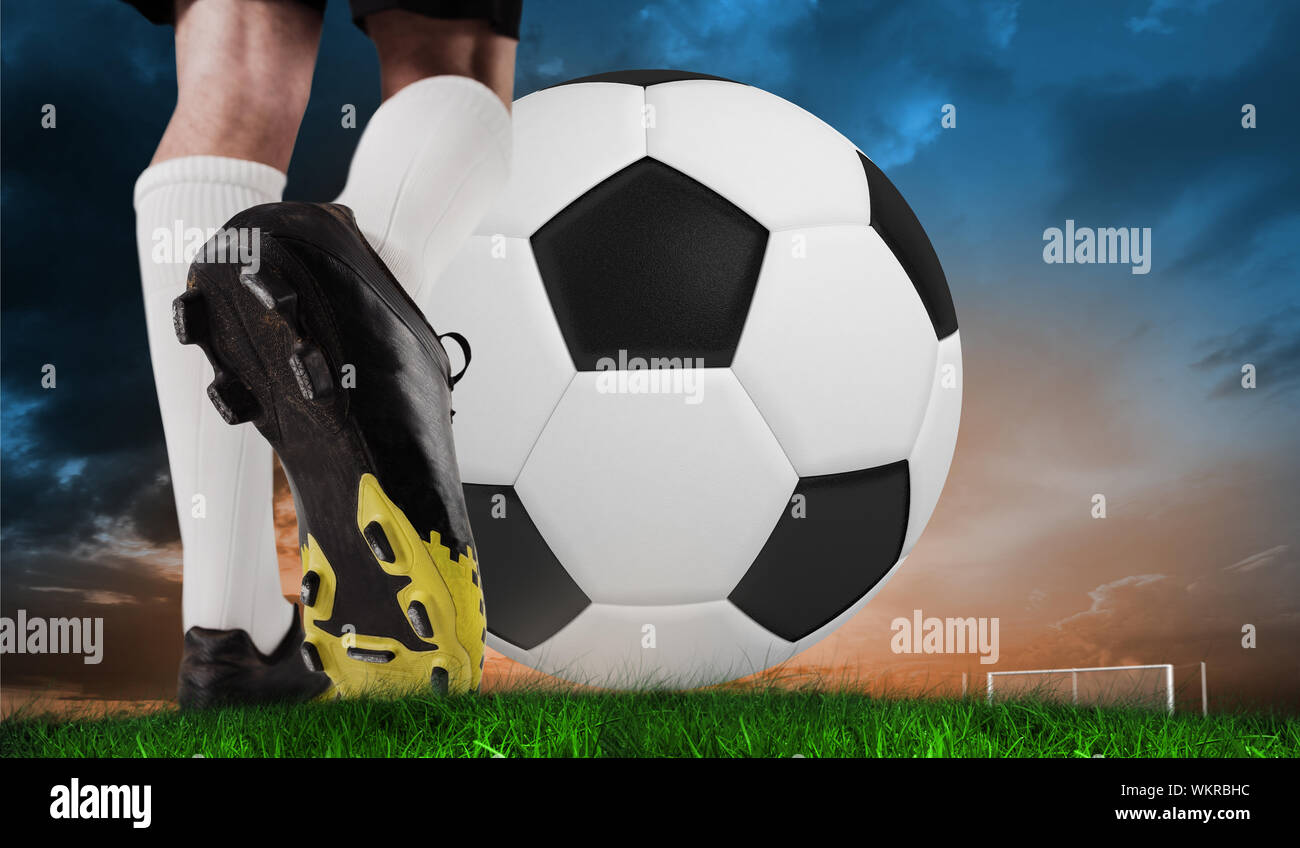 Composite image of football boot kicking huge ball against green grass ...