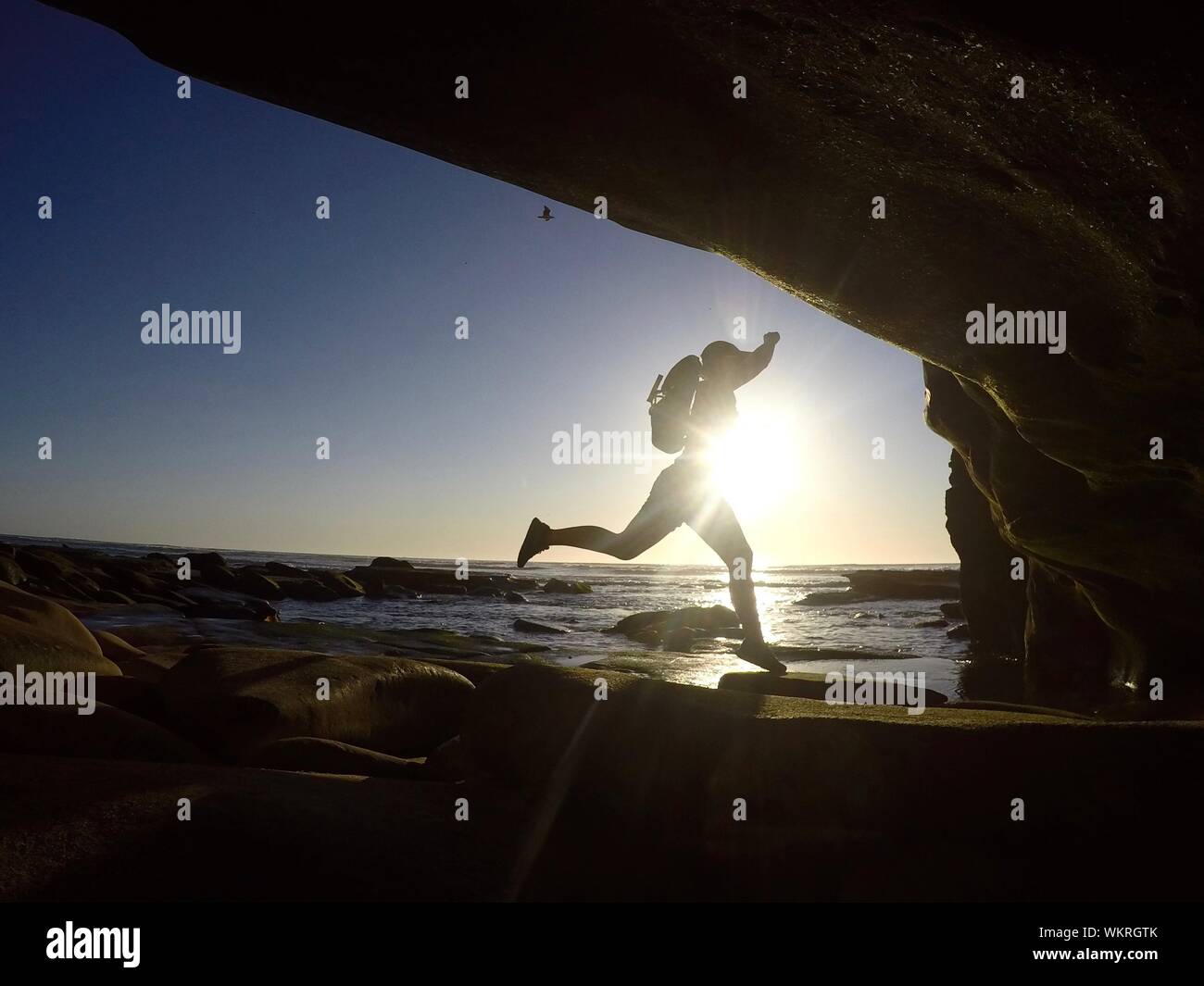 Woman jumping rock formation hi-res stock photography and images - Alamy